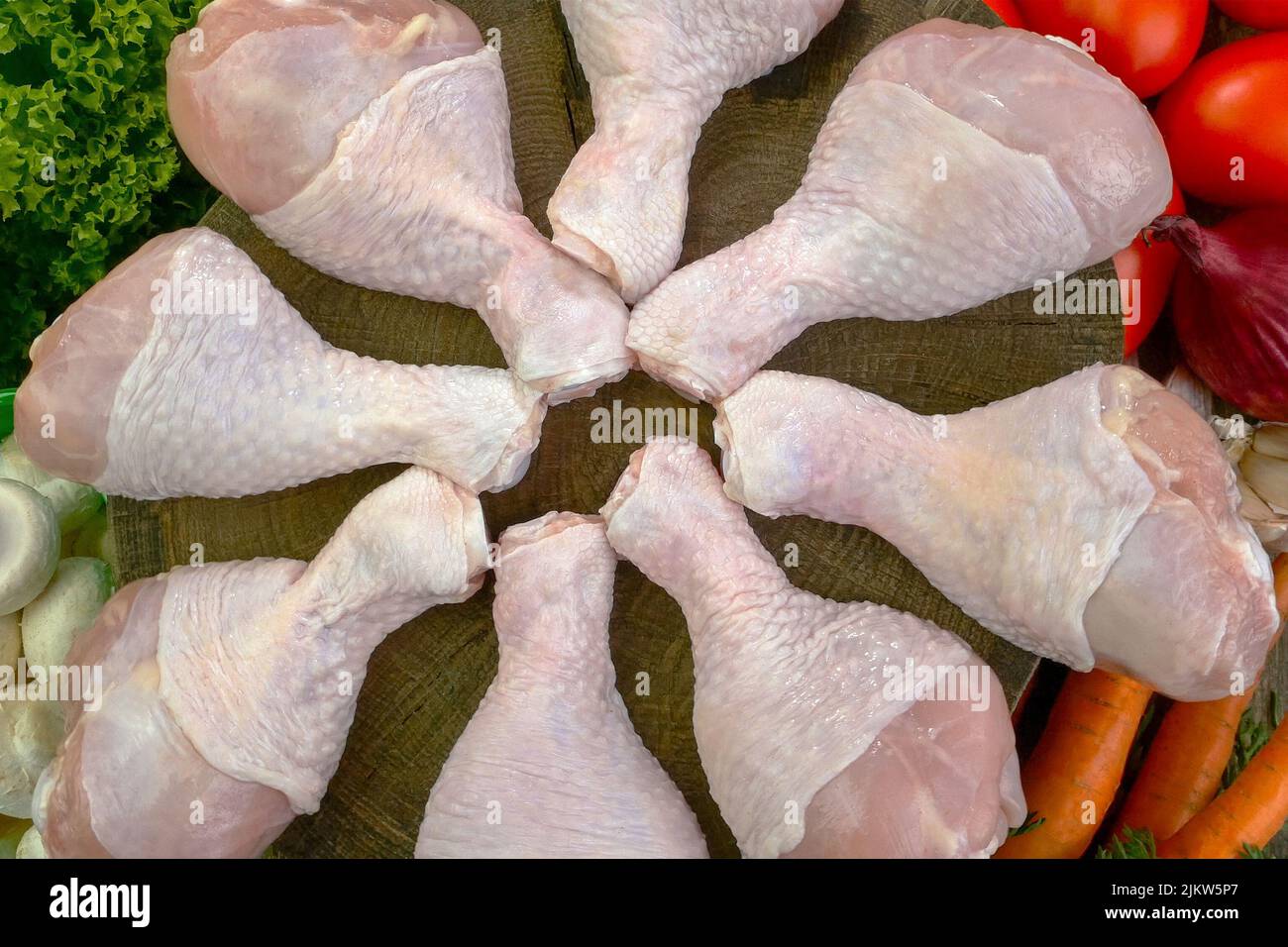 Fresh raw chicken drumsticks with vegetable as food background on ...