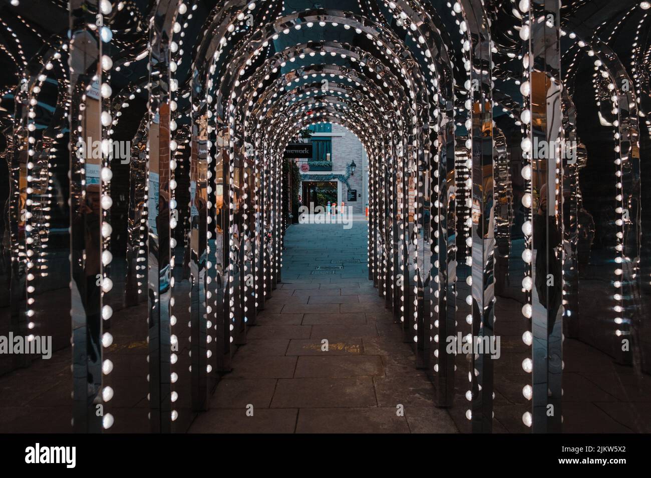 An arched walking path with decorative lights in London, UK Stock Photo ...