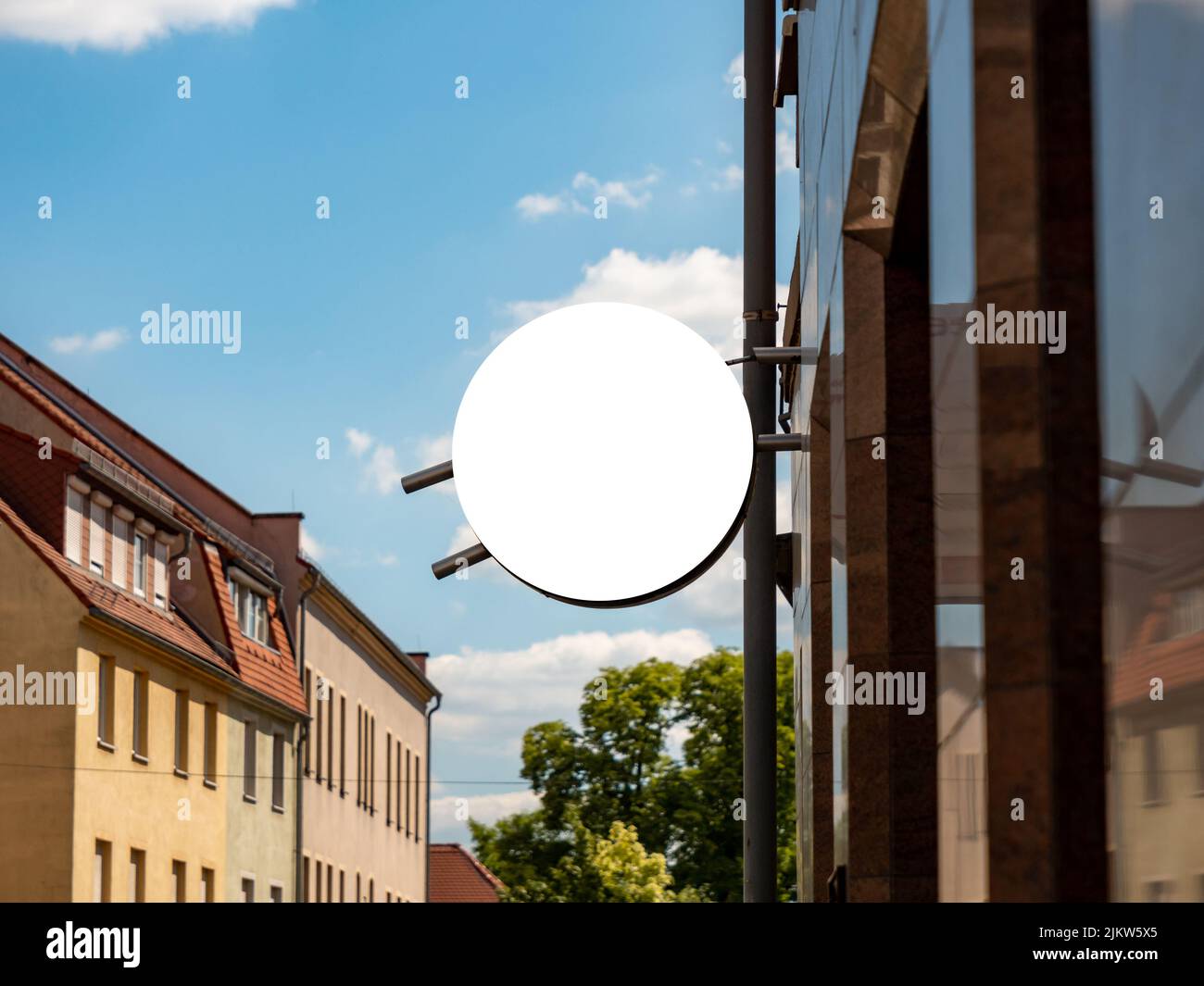 A blank sign as copy space on the wall of a house. Broken round ...