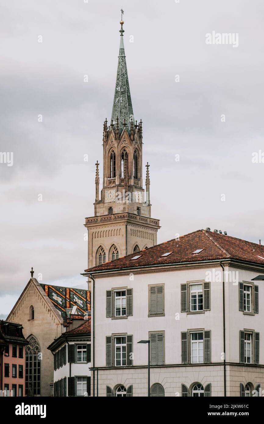 A vertical shot of an old historic buildings and a church tower in ...