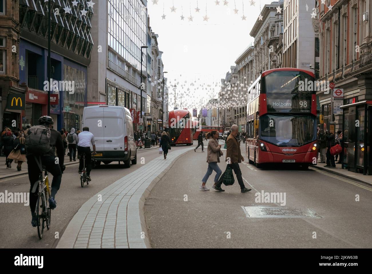 A busy road with buses and people in the center of London, UK Stock ...
