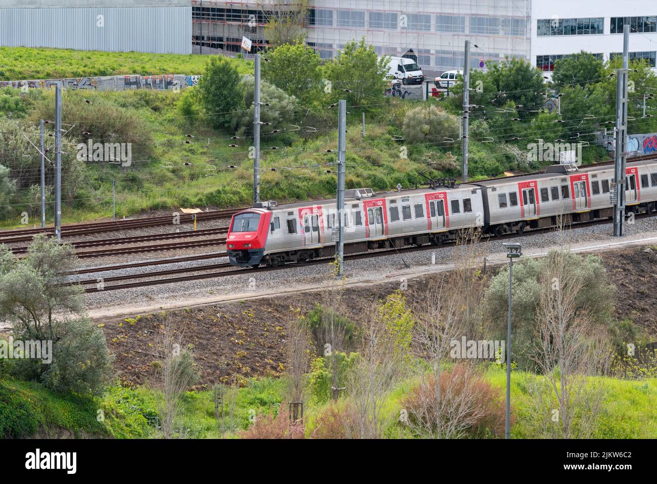 The Comboios de Portugal urban train passing through the city of Lisbon ...