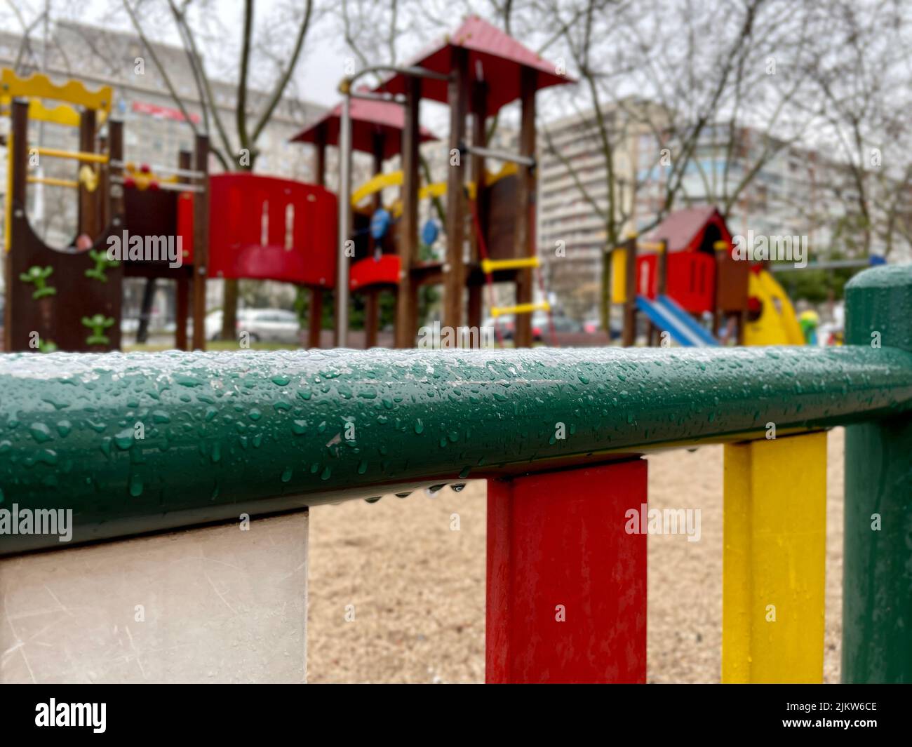 A closeup of The colorful fence with games and trees in children ...