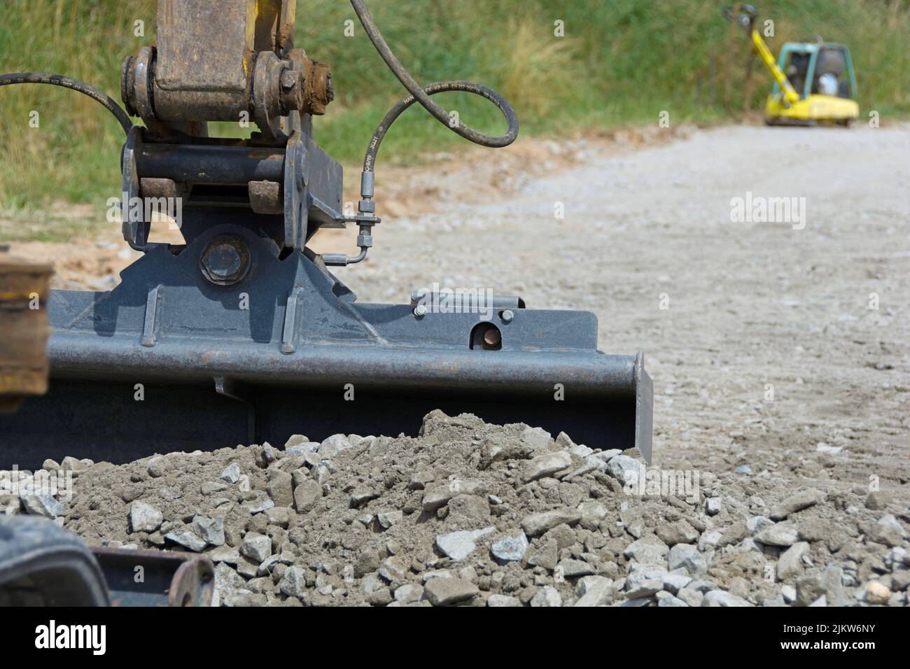 Excavator produces crushed stone planum Stock Photo - Alamy