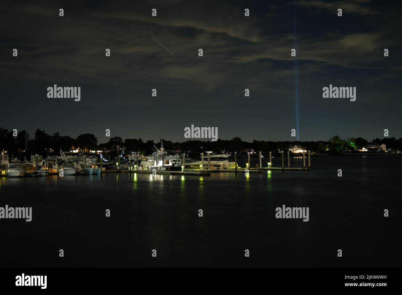 A scenery of the NYC bay with boats and the September 11 memorial blue ...