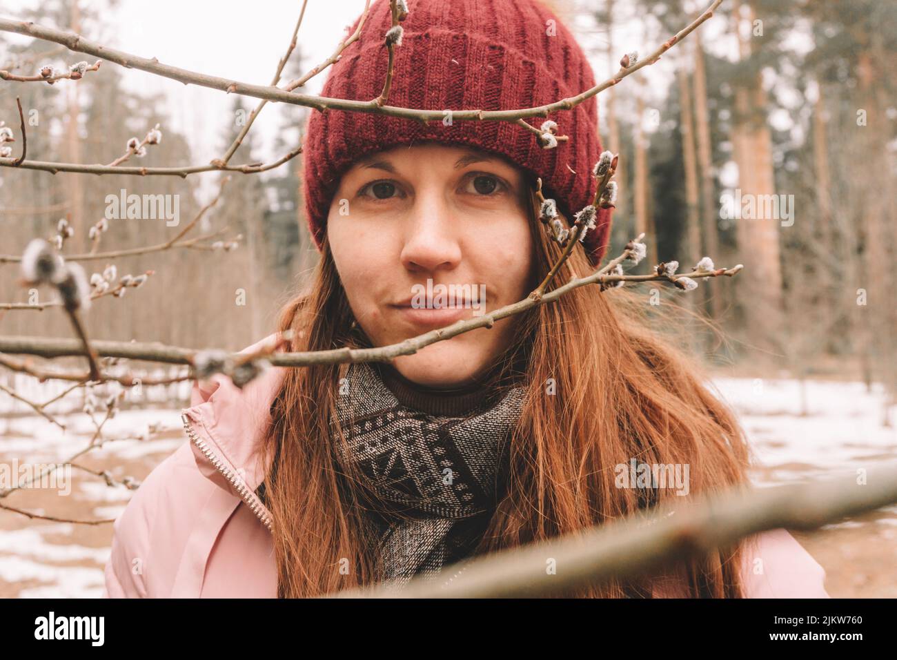 beautiful woman in a forest on a spring afternoon, still quite cold ...