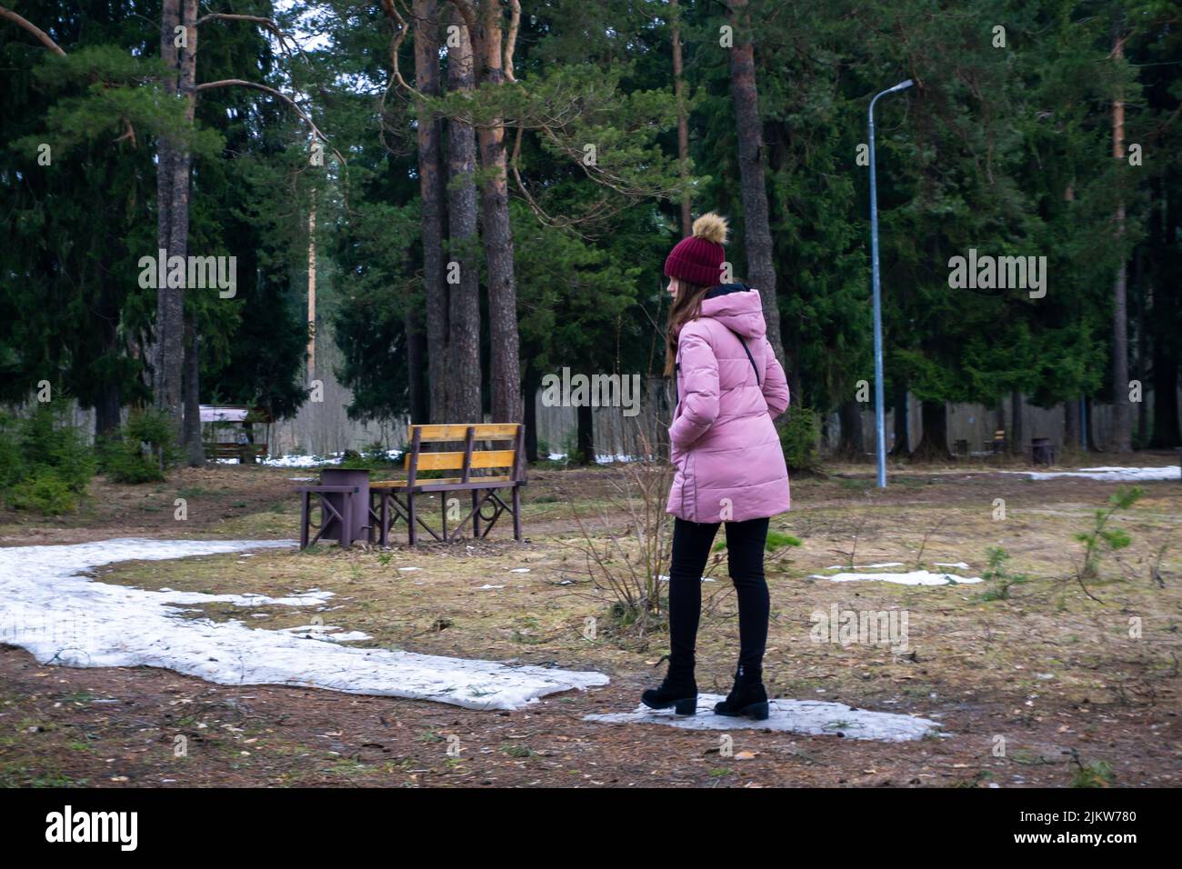 beautiful woman in a forest on a spring afternoon, still quite cold ...