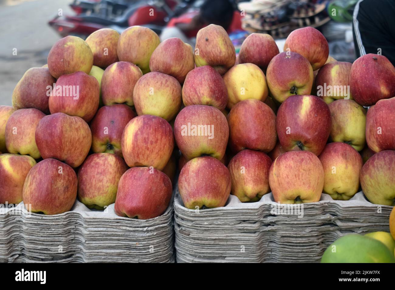 A Red and green apples on the market counter. Apples in the cardboard ...