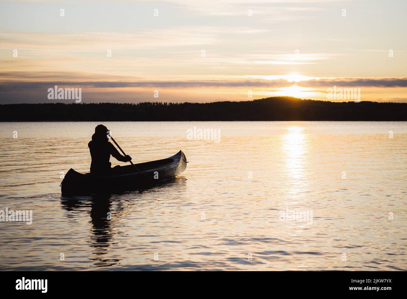 Paddling during the morning sun with a canoe Stock Photo - Alamy