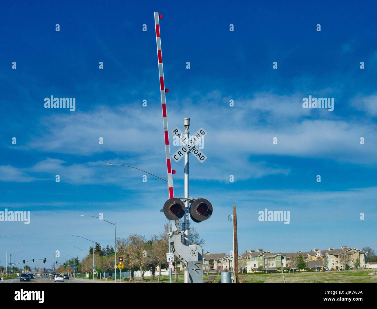 A railroad crossing light in Tracy, California, USA against a clear ...