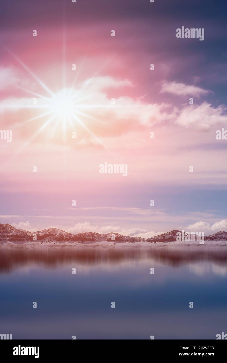 A vertical shot of mountains reflected in calm lake during scenic ...