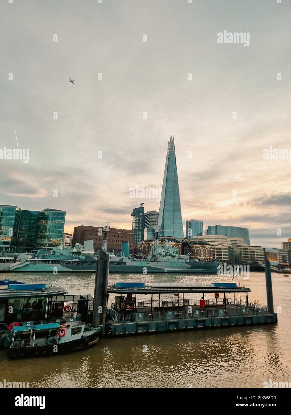 A view of harbor on Thames river in background of the Shard skyscraper ...