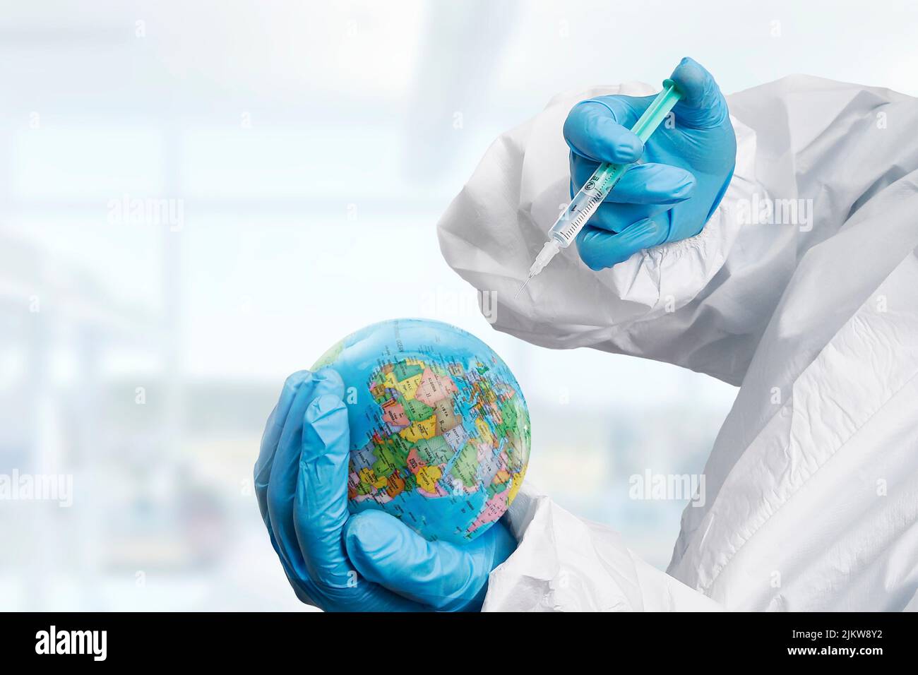 A doctor injecting syringe of Coronavirus vaccine on the planet earth ...