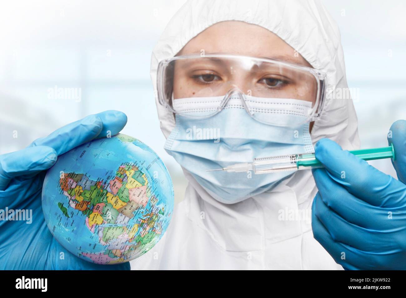 A doctor injecting syringe of Coronavirus vaccine on the planet earth ...