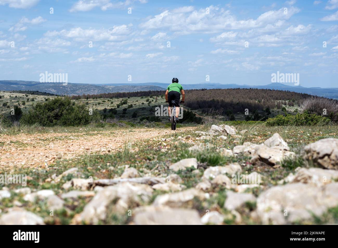 Mountain biker on trail high in the mountains Stock Photo - Alamy