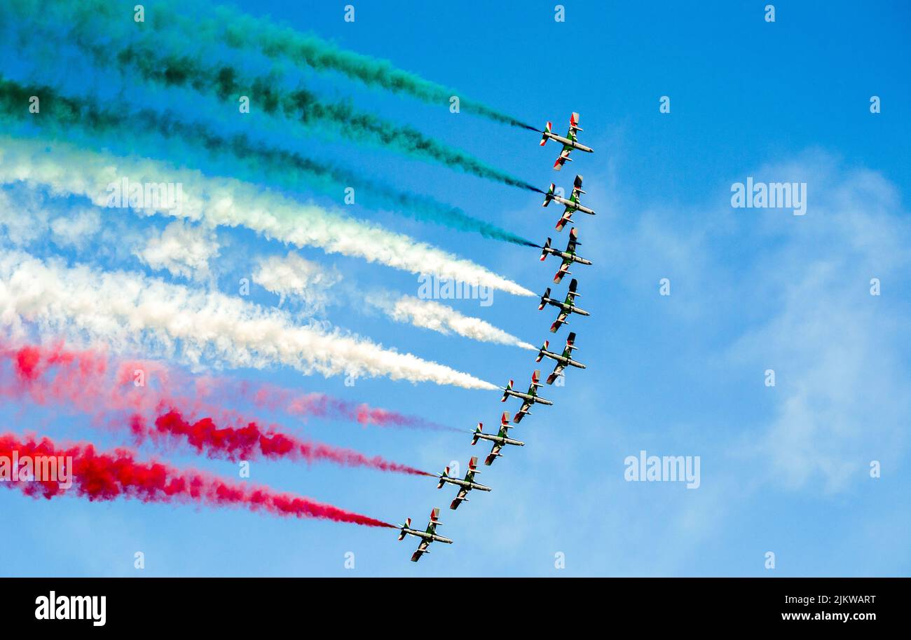 A beautiful shot of airplanes with smoke from them forming the flag of ...
