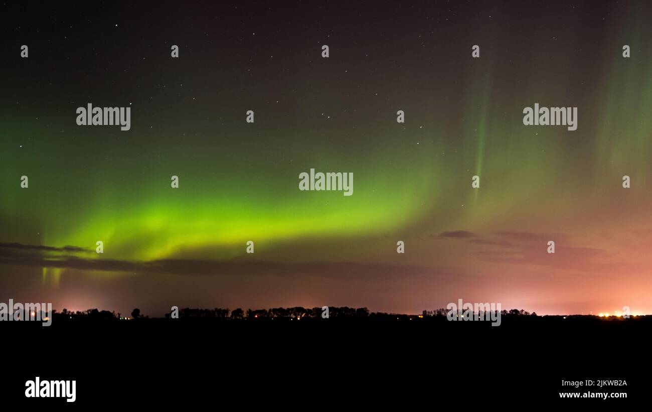 A beautiful scenery of the red and green aurora lights during night ...