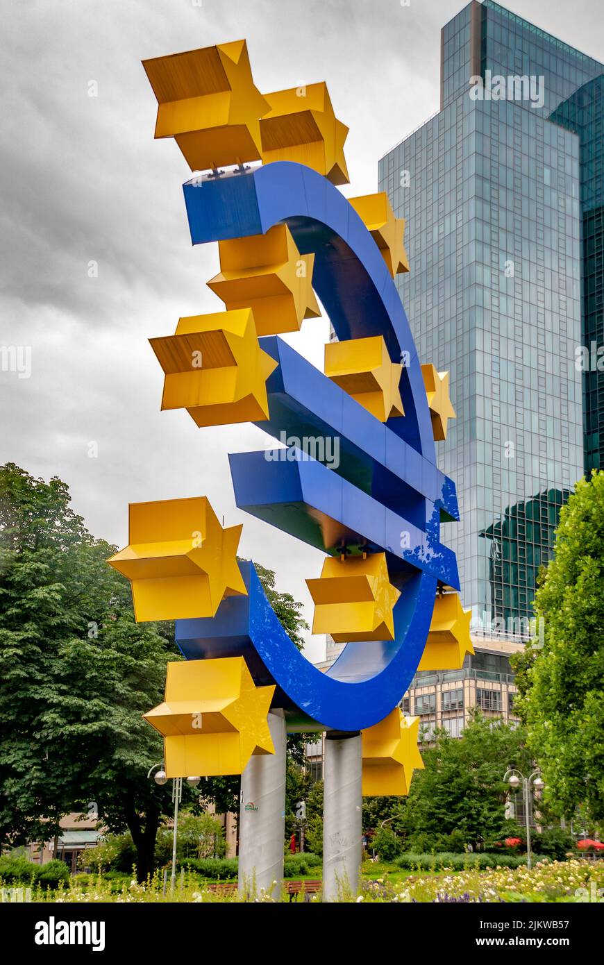 A Low angle of a large euro sign in front of a euro tower in Germany ...