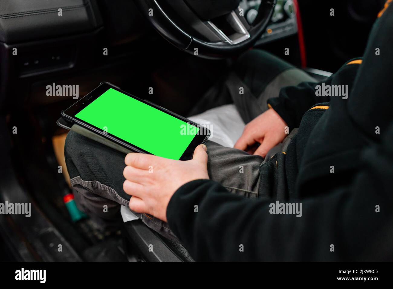 Car mechanic with tablet doing diagnostics detecting malfunction ...