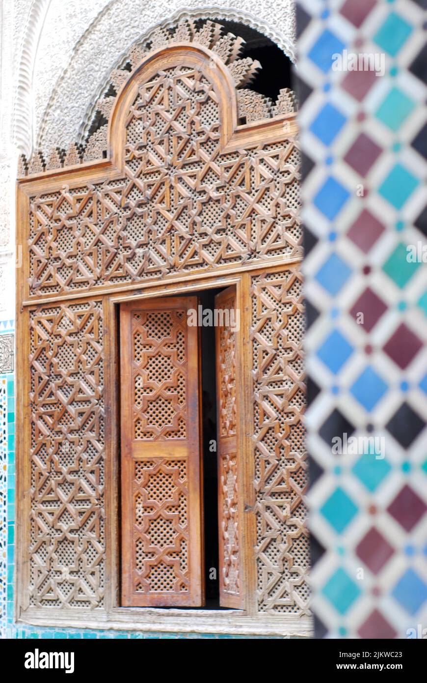 Wooden carved window with shutters and colorful tile in foreground in Marrakech Morocco Stock ...