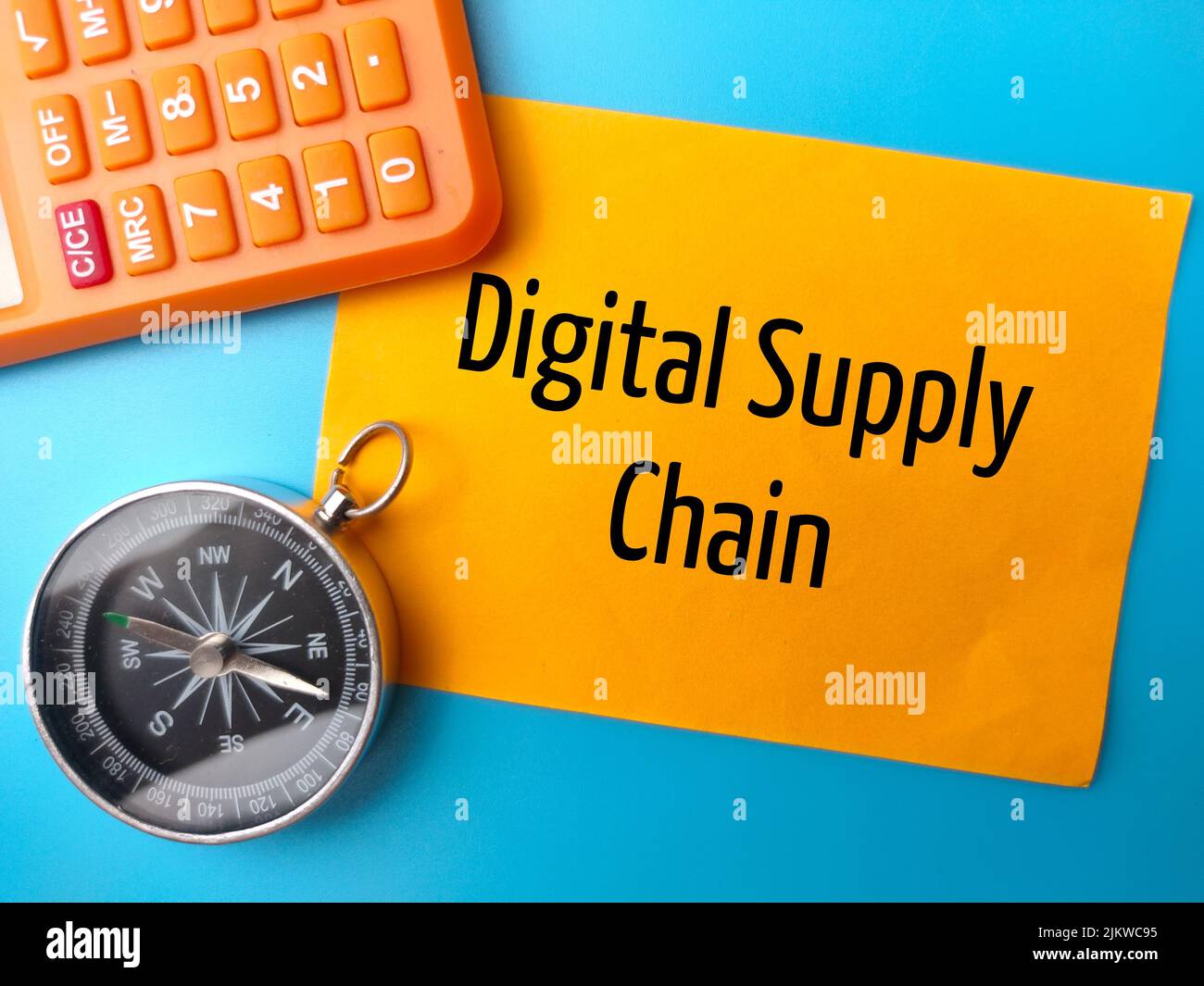Compass,calculator and colored notepaper with text Digital Supply Chain ...