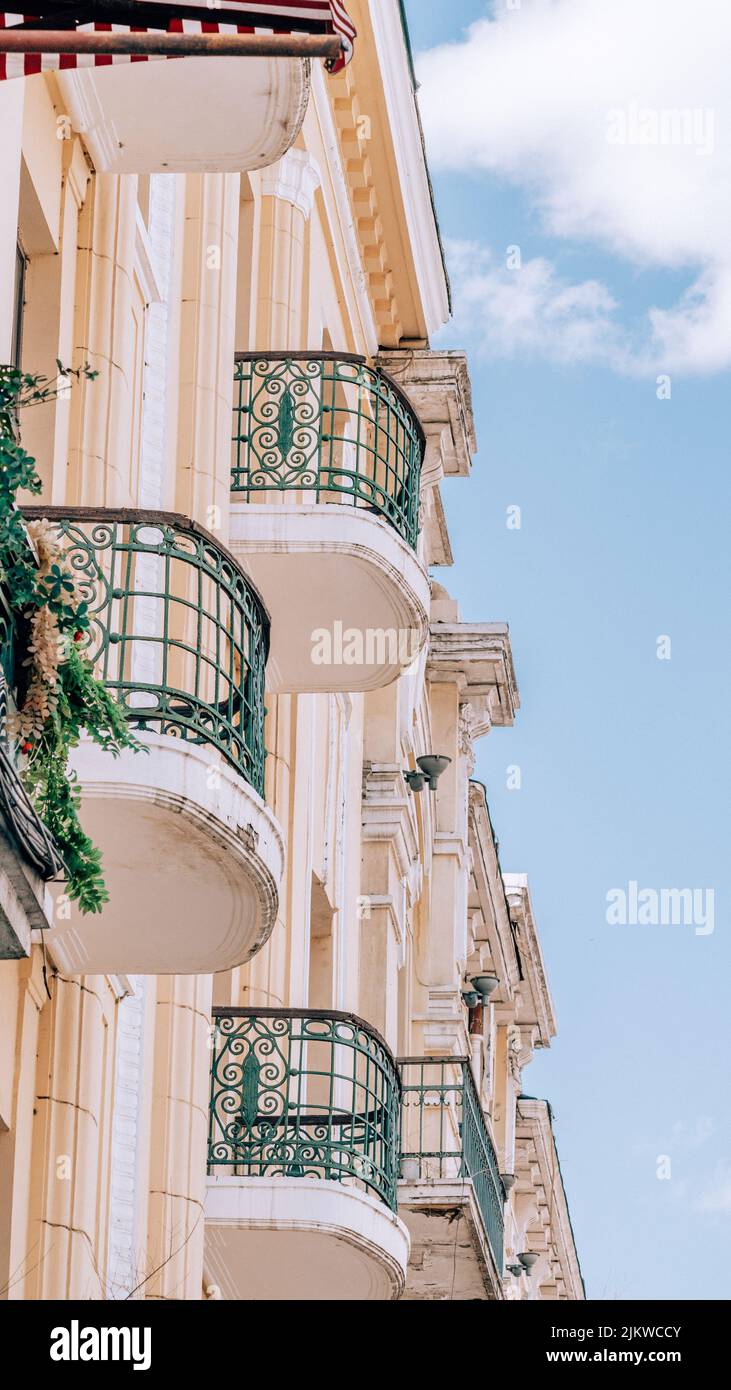 A low-angle shot of balconies of an apartment building against a blue ...