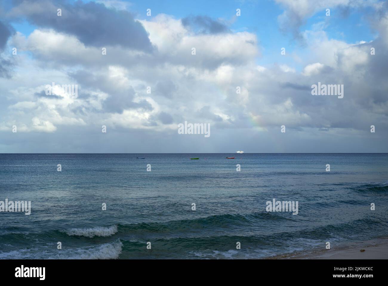 A closeup of a scenic morning seascape with sailboats in the ocean ...