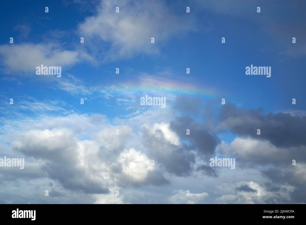 Cloudy sky with rainbow hi-res stock photography and images - Alamy