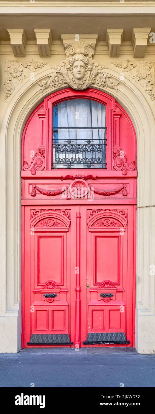 Paris, an ancient red door, typical building in the 11e arrondissement ...