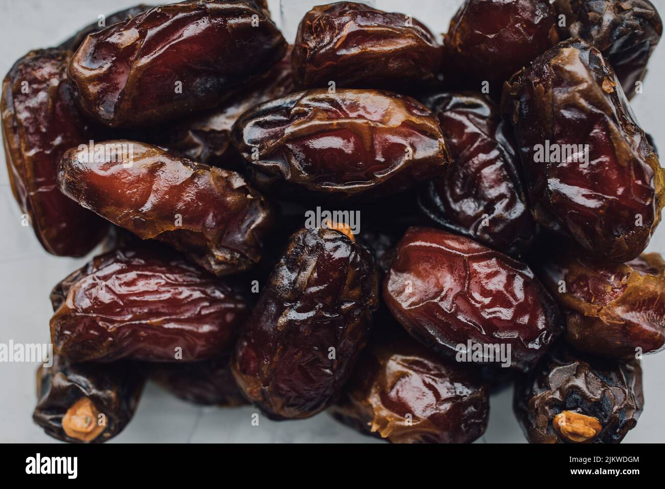 clear plastic box of brown dates, fruit background Stock Photo - Alamy
