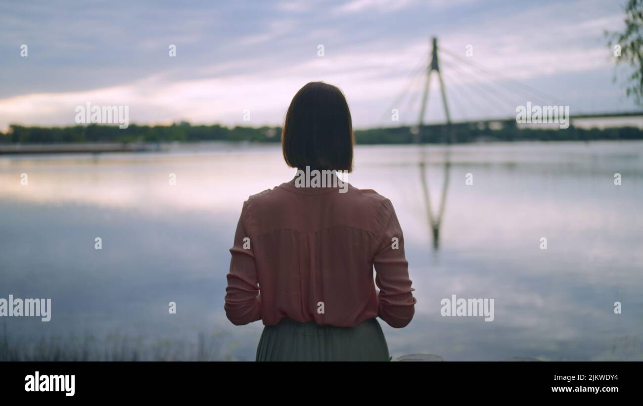 A back view of a female admiring a lake view Stock Photo - Alamy