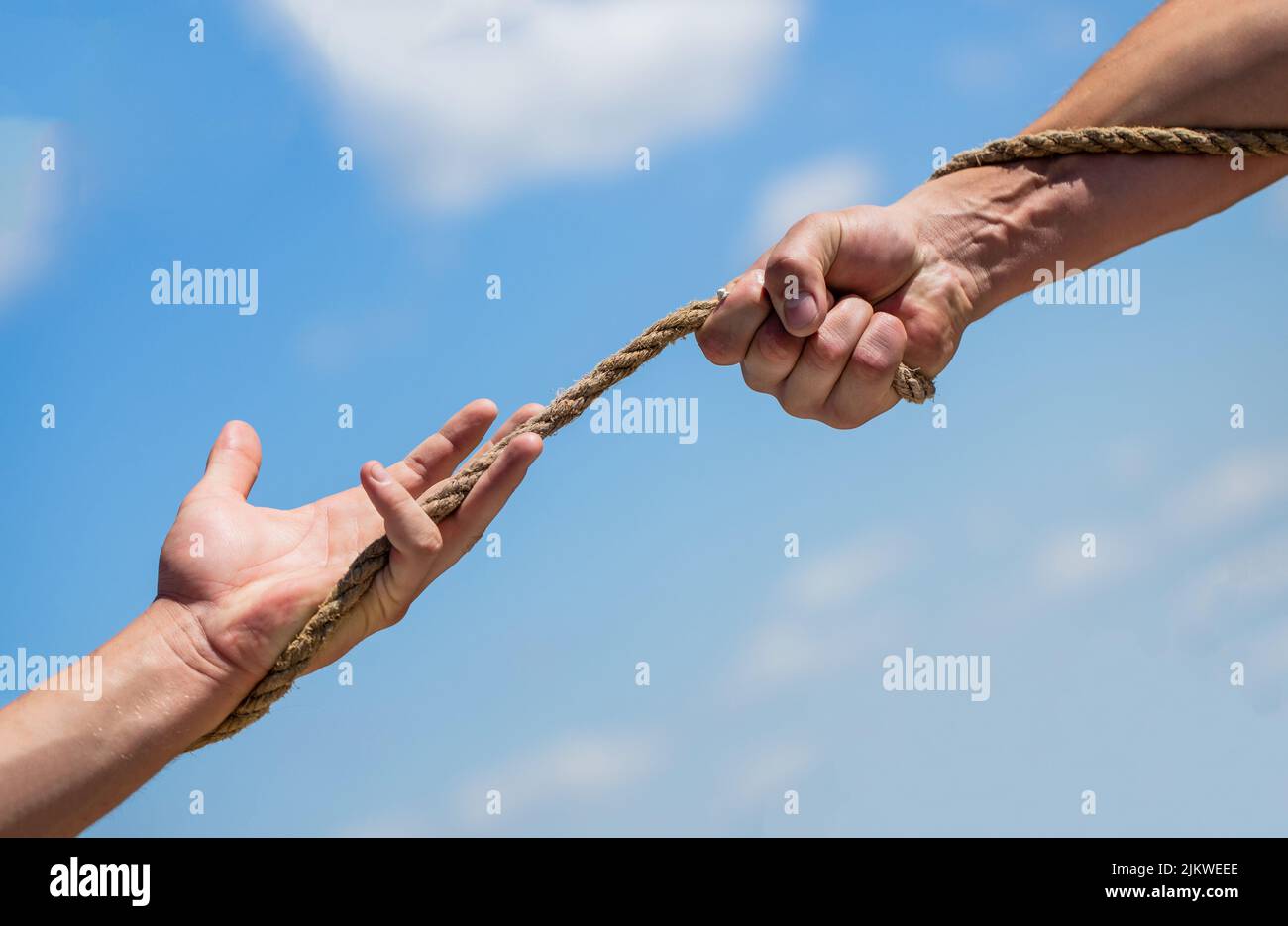 Rescue, help, helping gesture or hands. Conflict tug of war. Rope, cord. Hand holding a rope ...