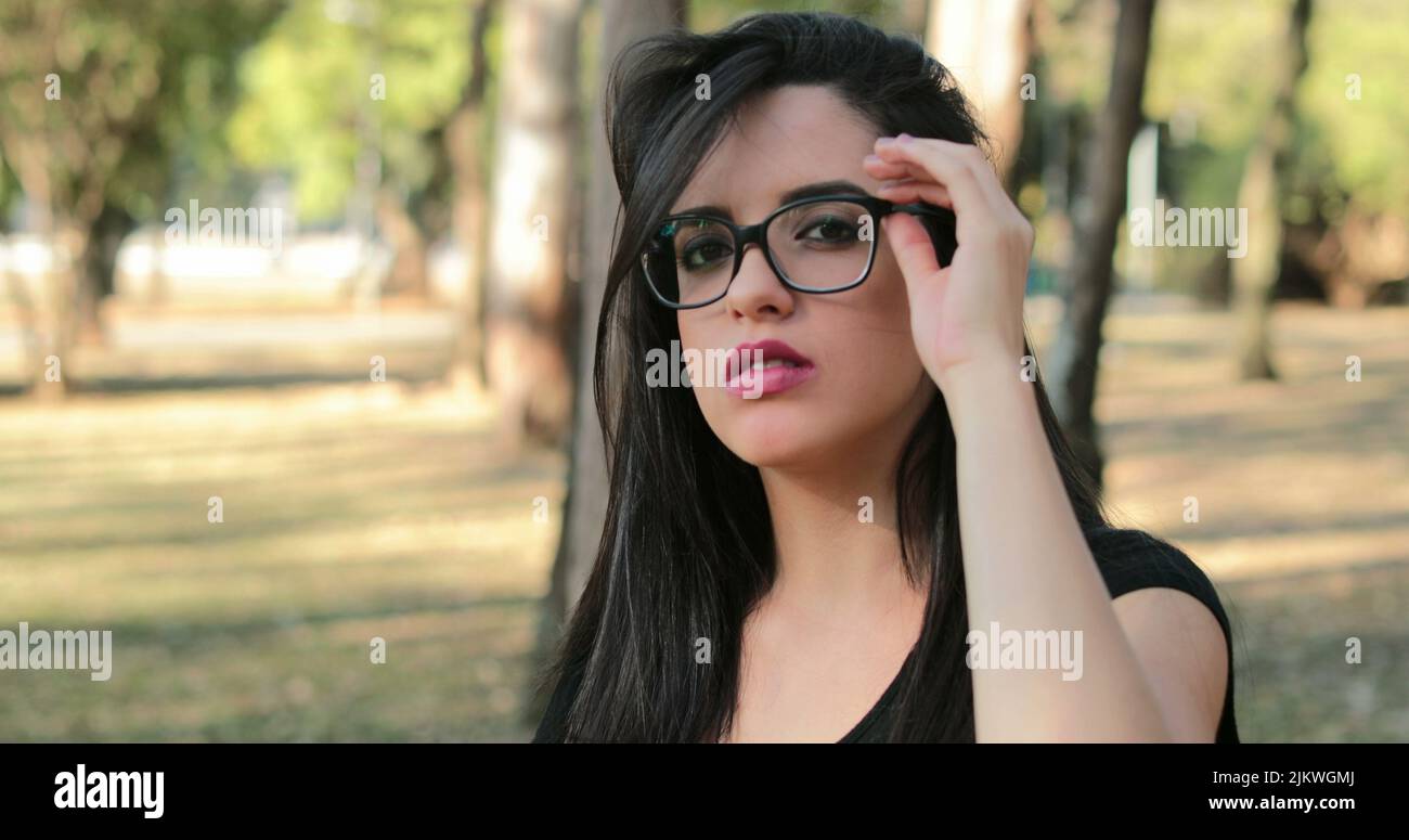 woman wearing glasses looking to camera with a serious smart expression Stock Photo - Alamy