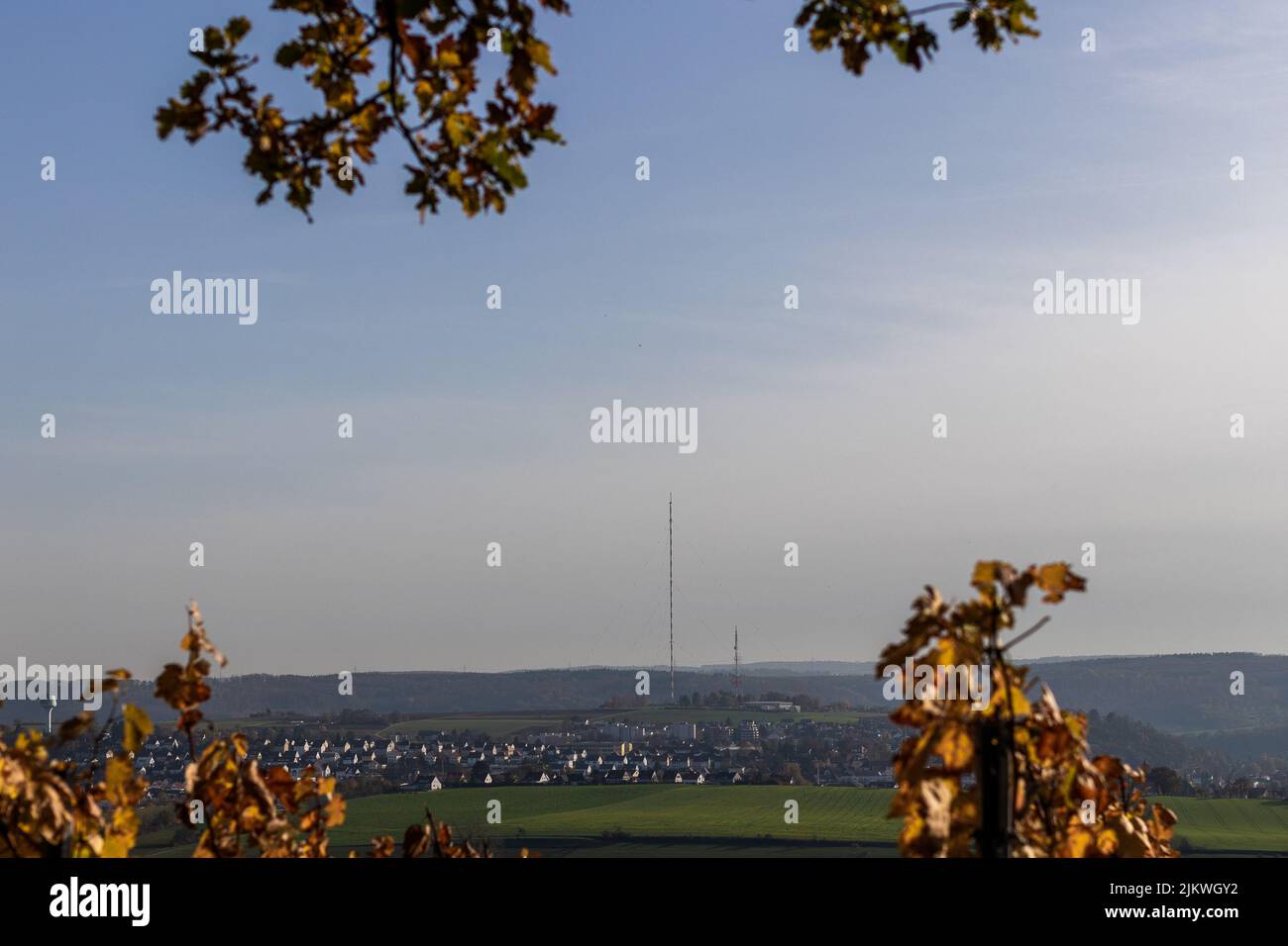 A distant view of a landscape with houses and fields during sunset ...