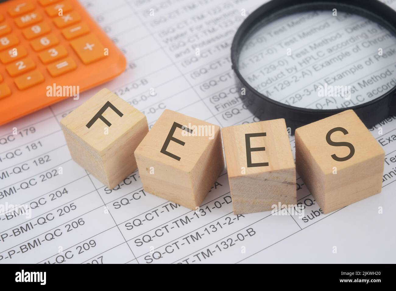 A high angle shot of wooden cubes with the writing fees on them Stock ...