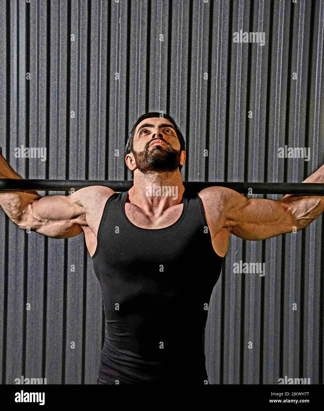 A vertical shot of a fit athletic muscular Caucasian man working out at ...