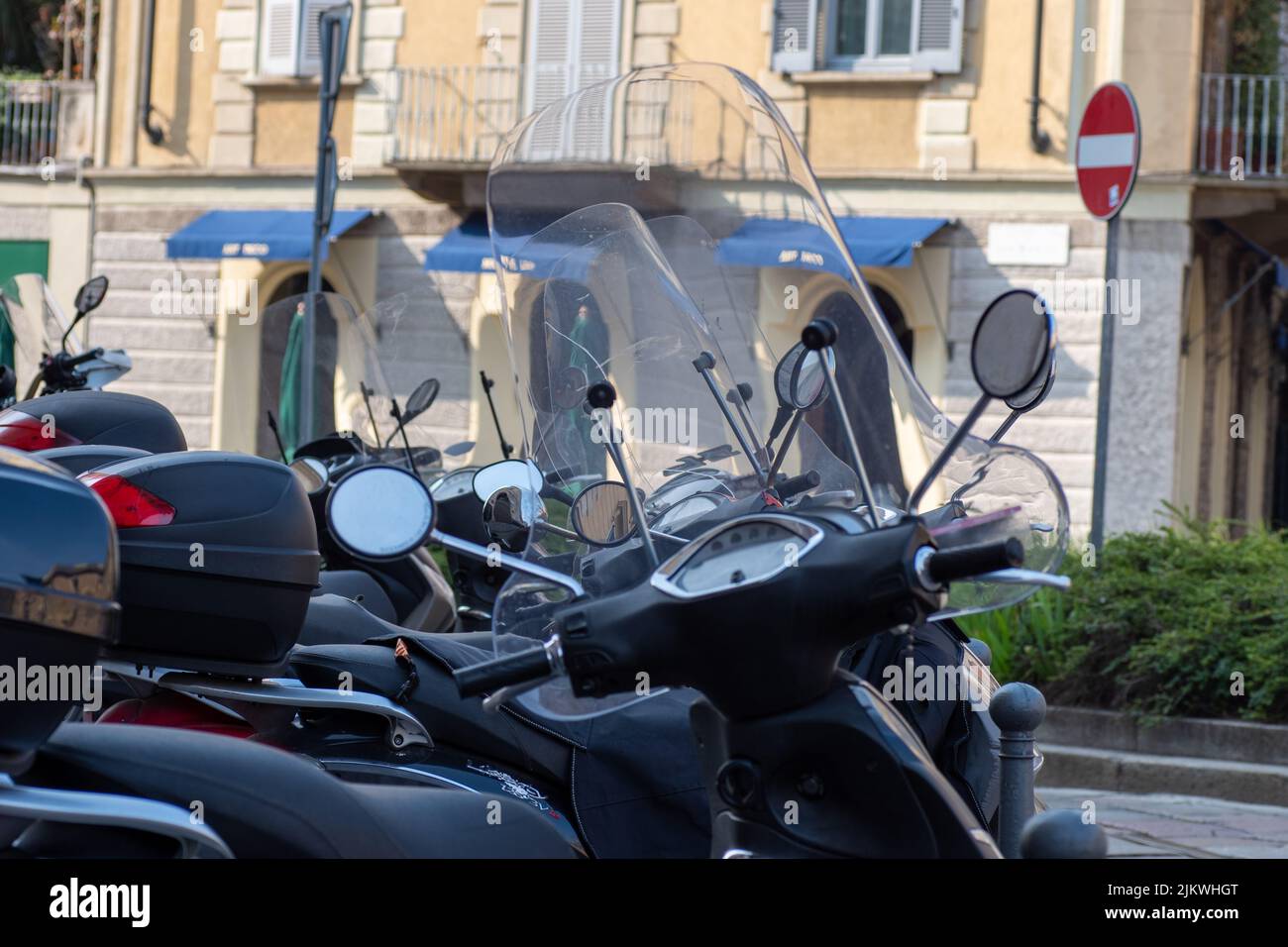 A row of motorcycles with windshields and boxes parked outdoors Stock ...