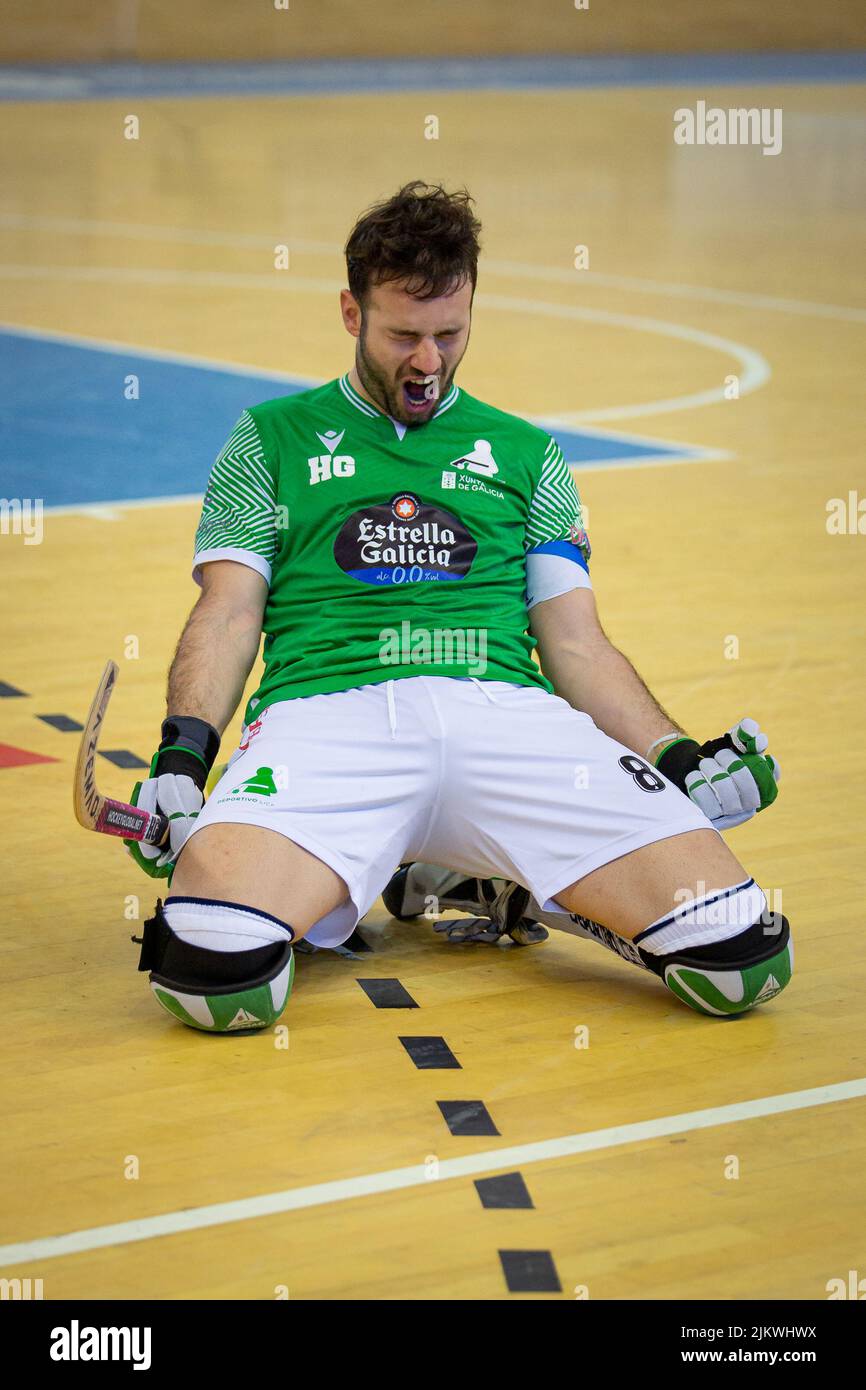 A vertical shot of a roller hockey player on his knees- in a ...