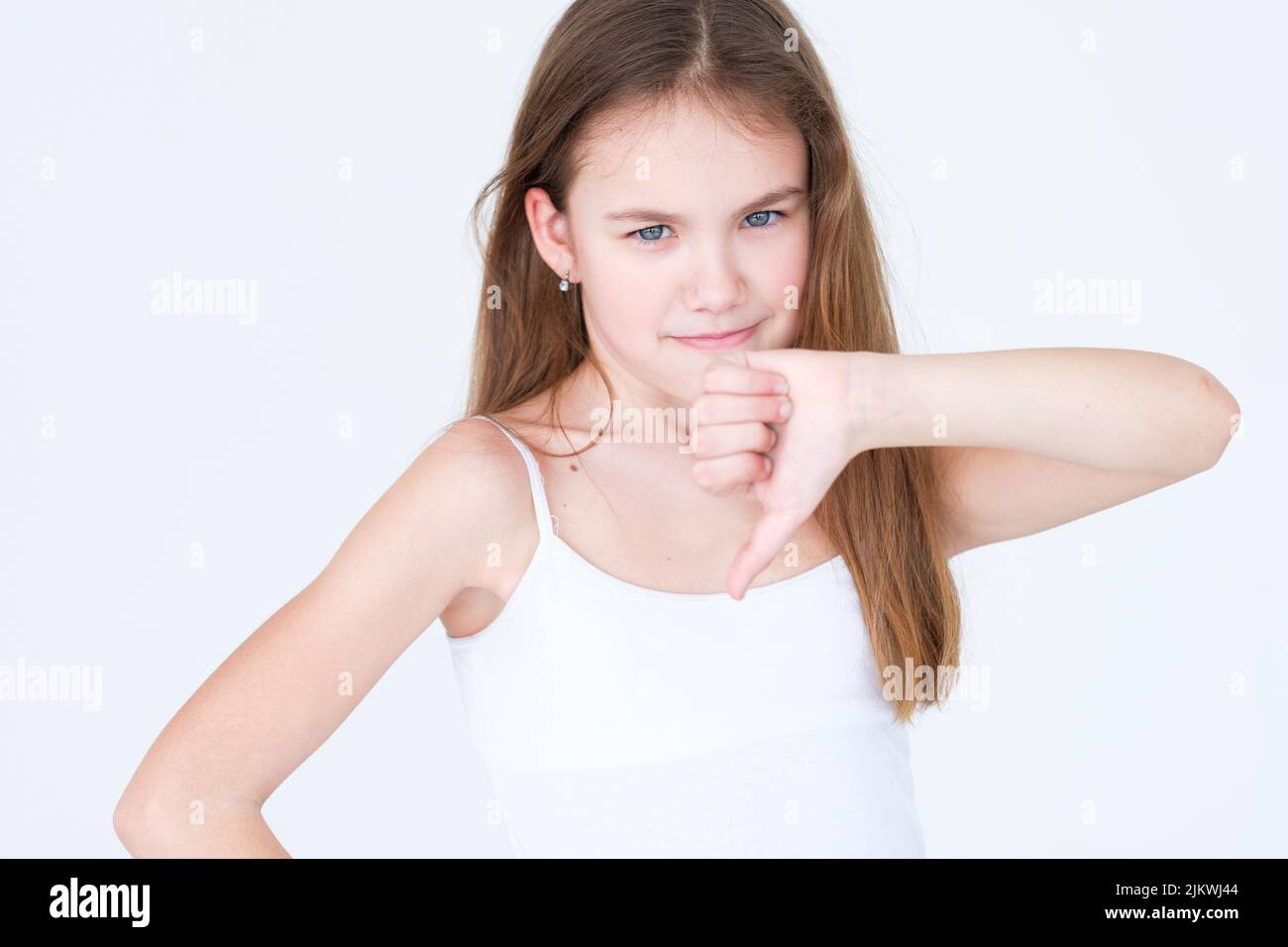 emotion disapproving annoyed child thumb down girl Stock Photo - Alamy