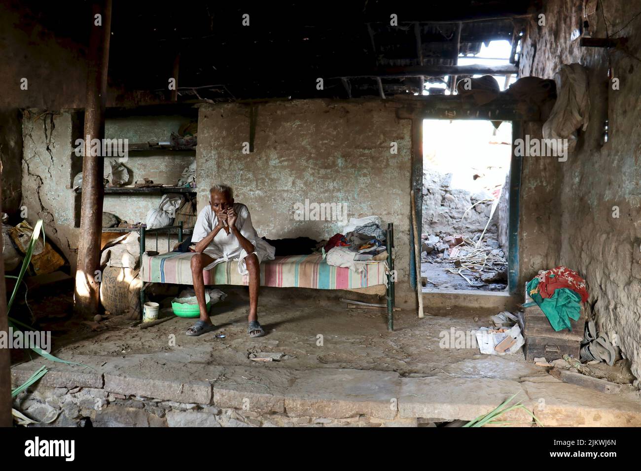 A selective focus of an Indian poor village old man in village attire ...
