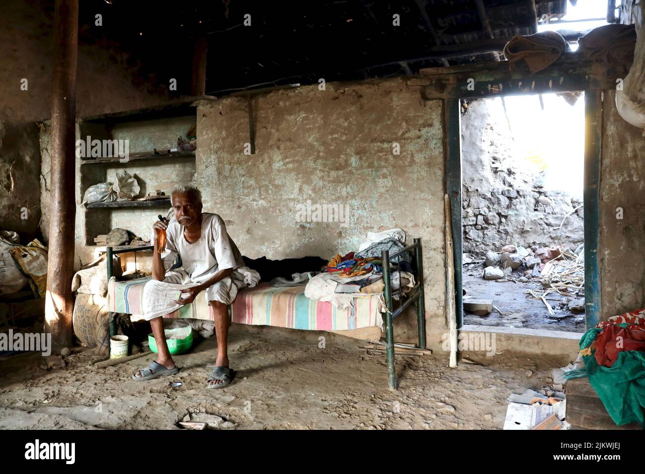 A selective focus of an Indian poor village old man in village attire ...