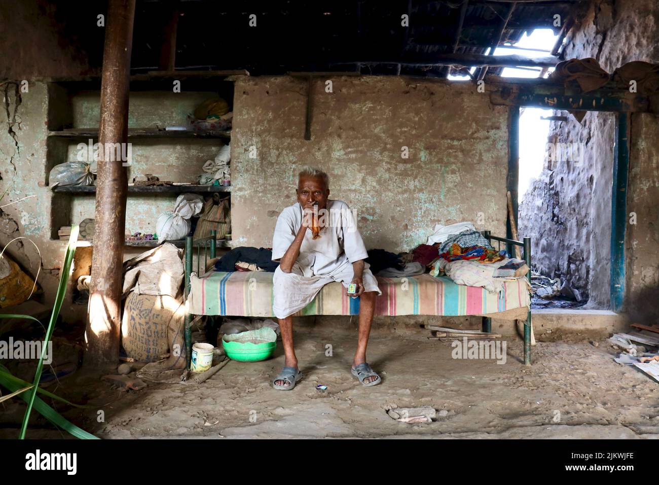 A selective focus of an Indian poor village old man in village attire ...