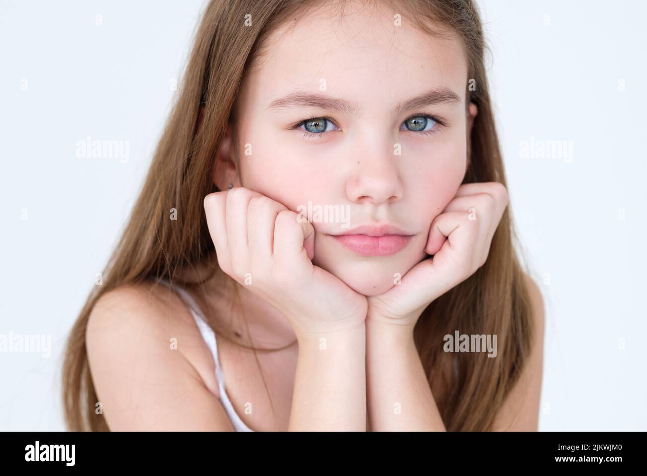 emotion cute pretty little girl hand chin innocent Stock Photo - Alamy