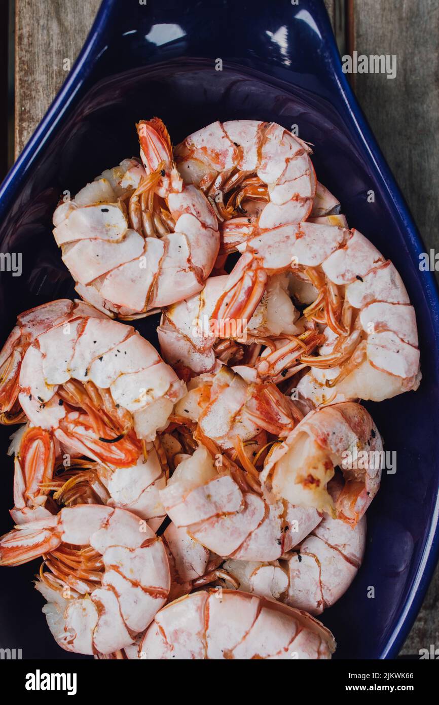 Grilled barbecued prawns in blue dish outdoors Stock Photo - Alamy