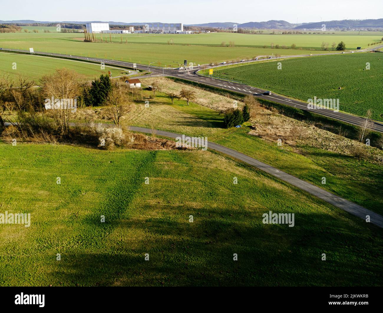 An aerial drone shot of a country landscape with trees and agricultural ...