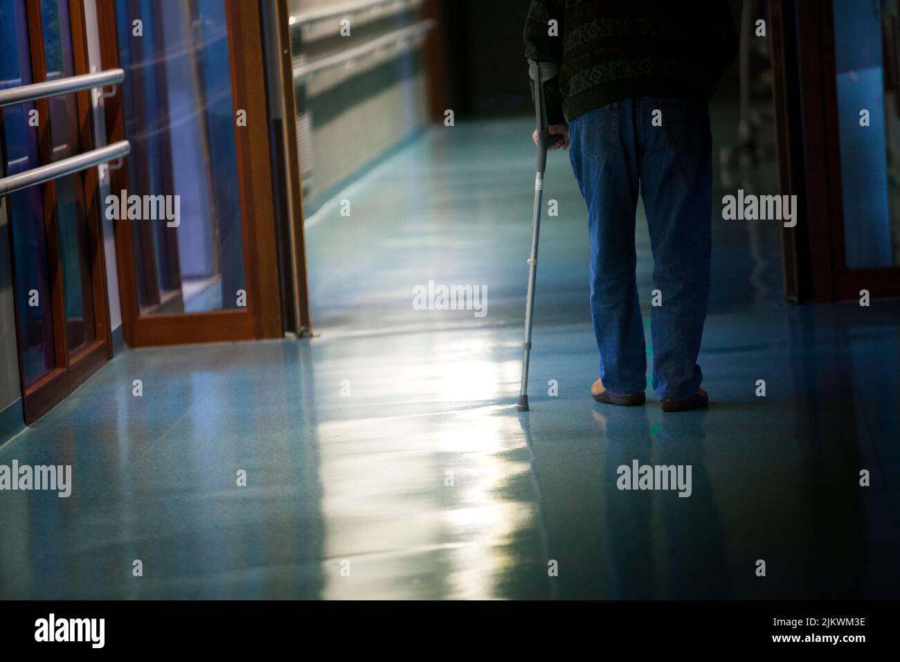Elderly man with his cane in a hallway of a retirement home Stock Photo ...