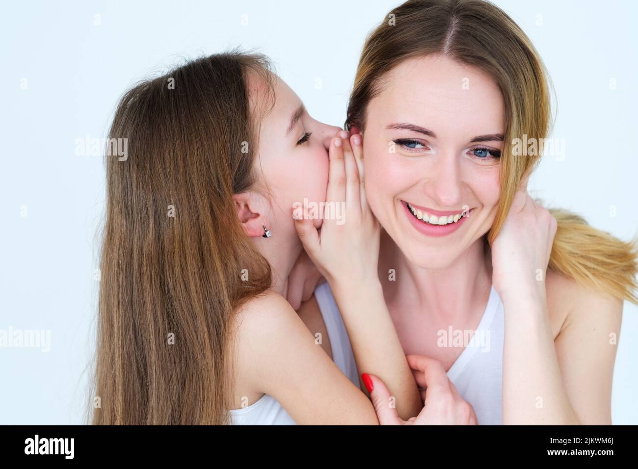 family bond secret family relationship whisper ear Stock Photo - Alamy