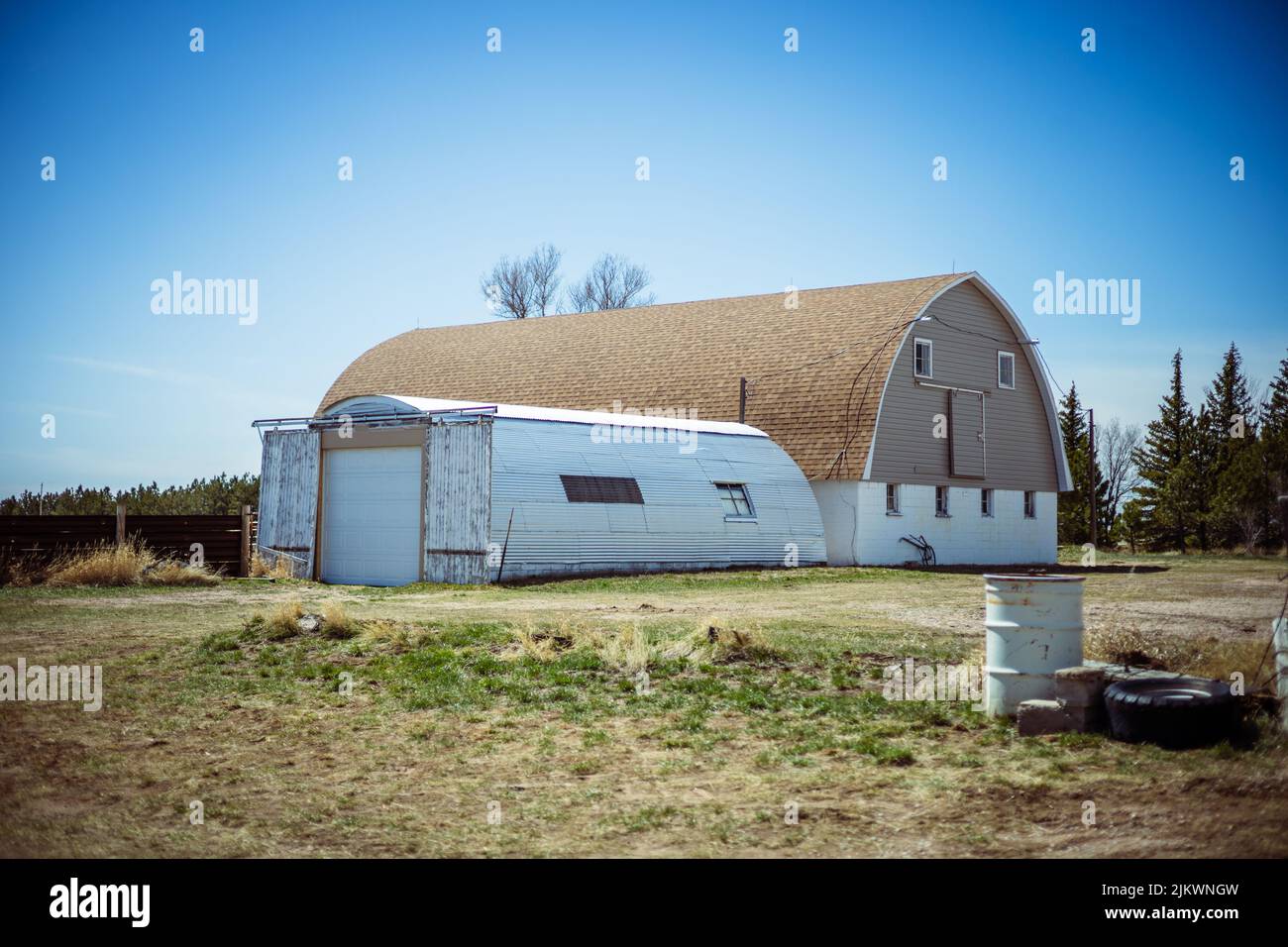 A beautiful shot of a barn in the middle of a field during the day ...