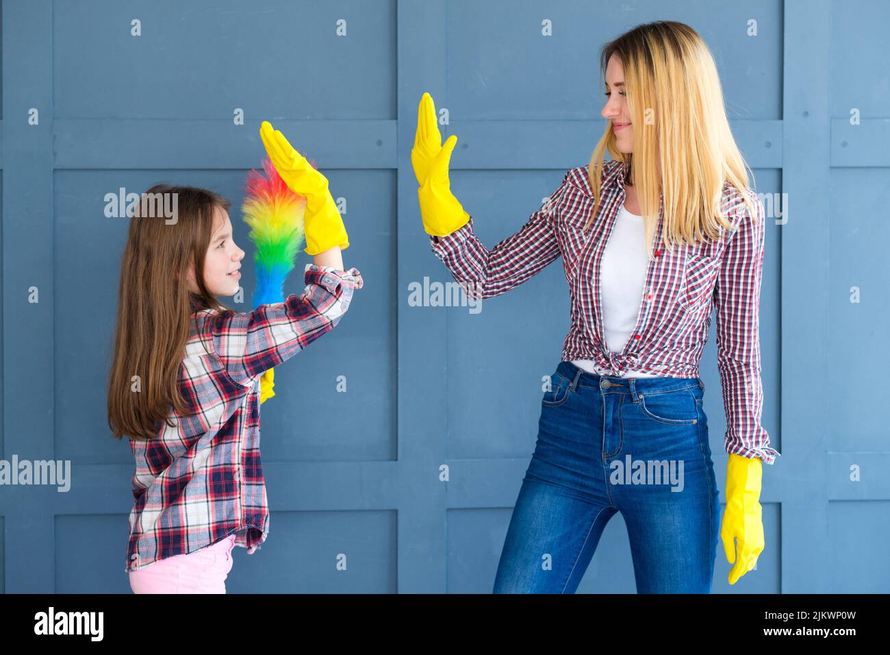 family teamwork household chores mom kid high five Stock Photo - Alamy