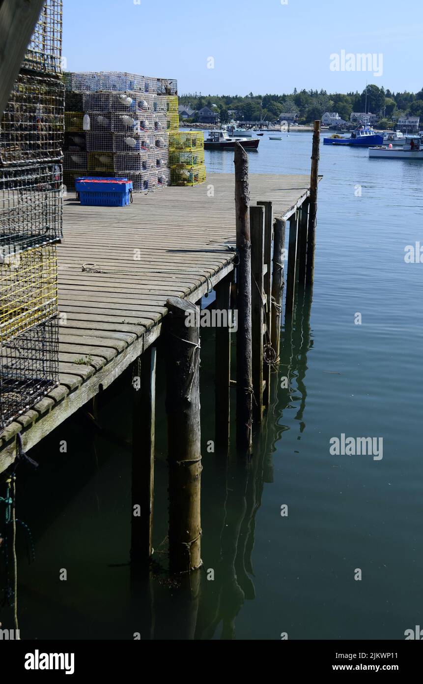 A vertical shot of a wooden pier or berth over the channel with a port ...